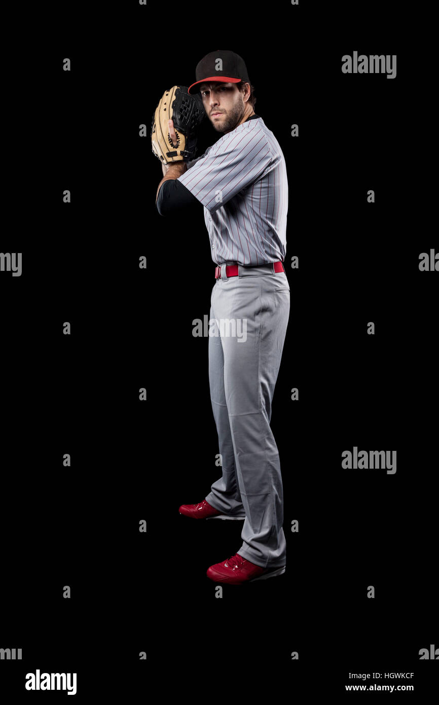Baseball Player pitching a ball on a black background. Studio Shot ...