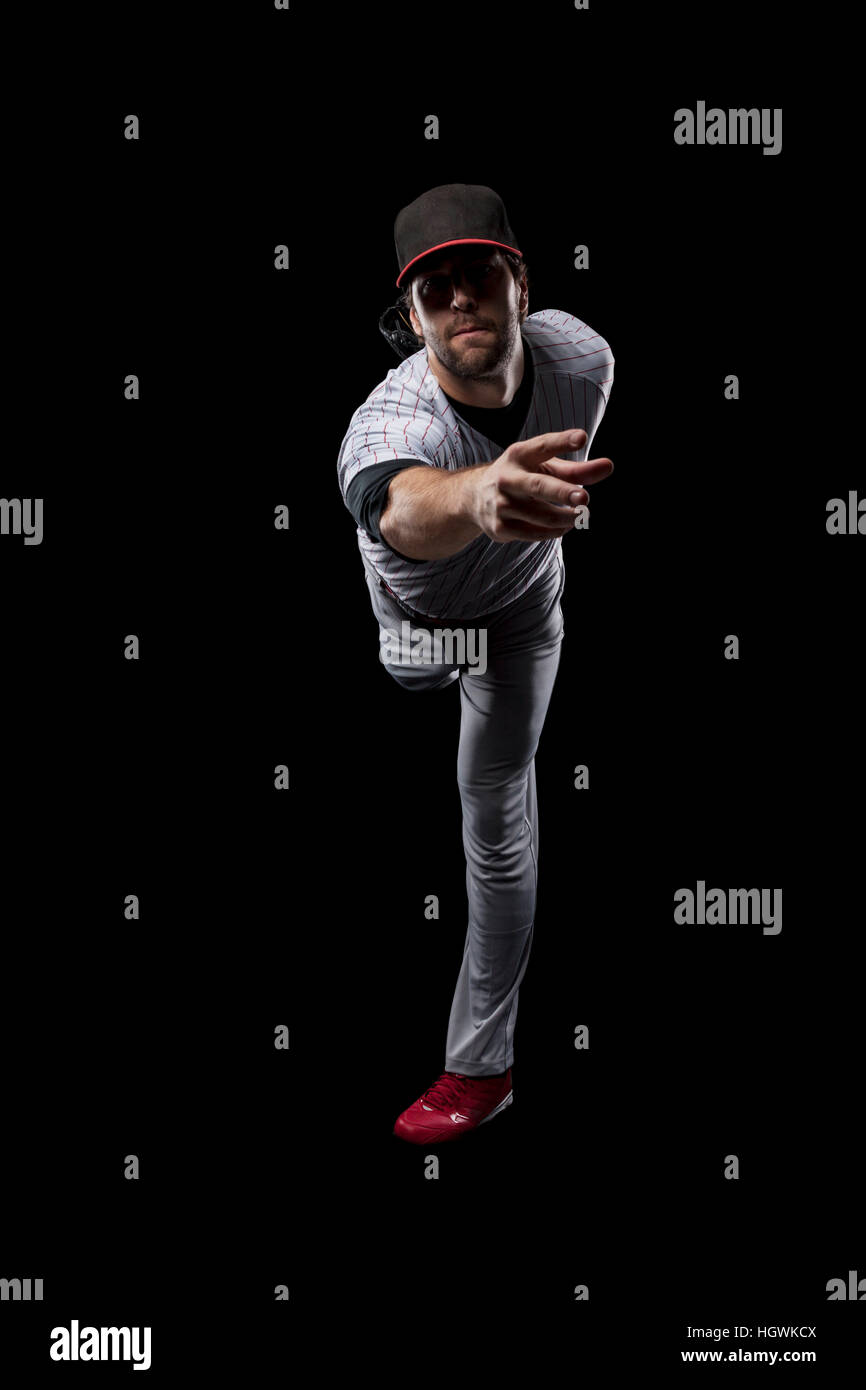 Baseball Player pitching a ball on a black background. Studio Shot ...