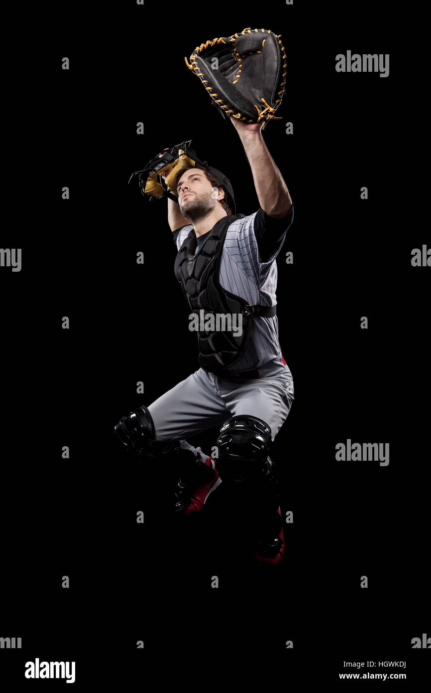 Baseball Player, catcher catching a wild pitch, on a black background ...