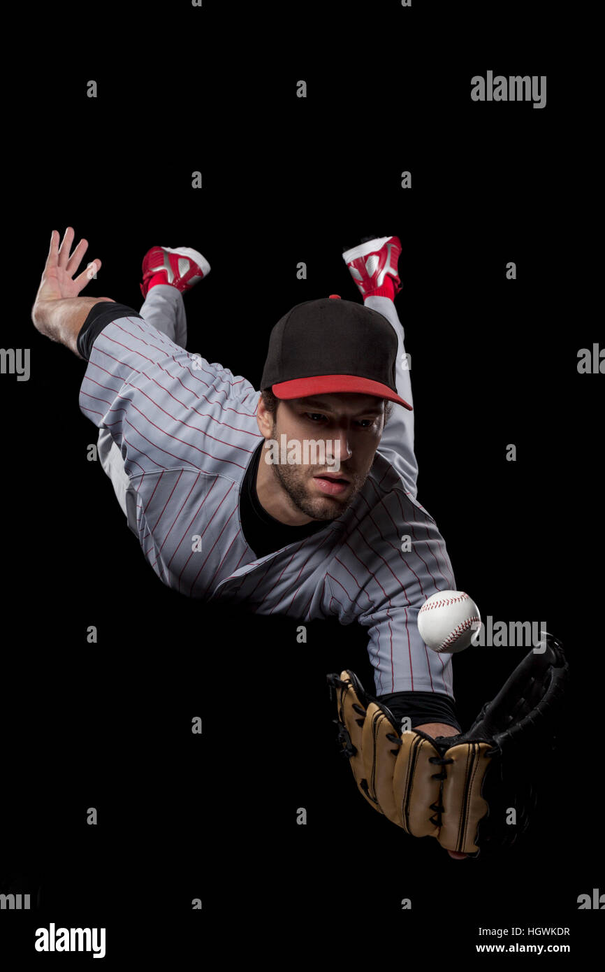 Baseball Player catching a ball on a black background. Studio Shot ...
