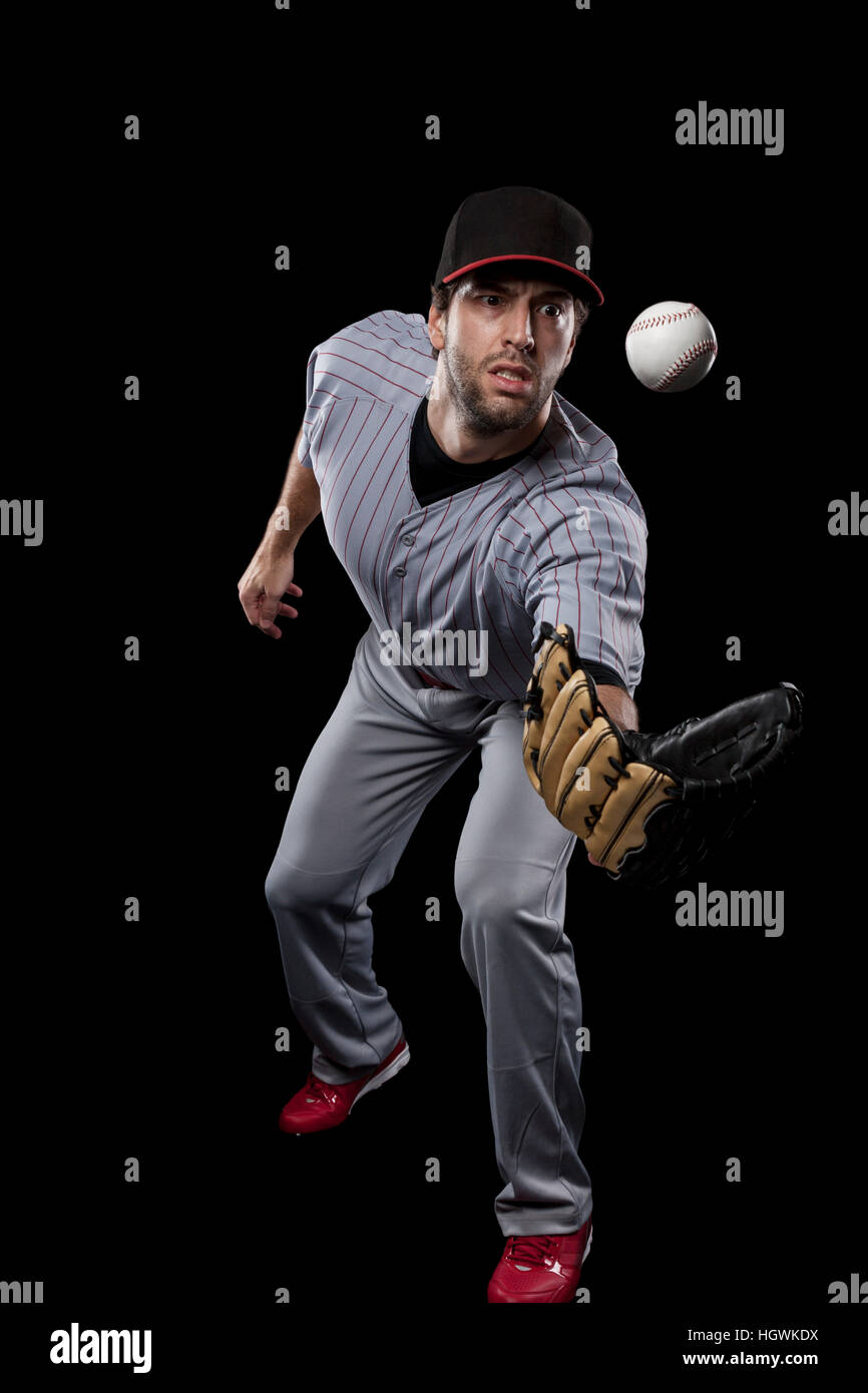 Baseball Player catching a ball on a black background. Studio Shot ...