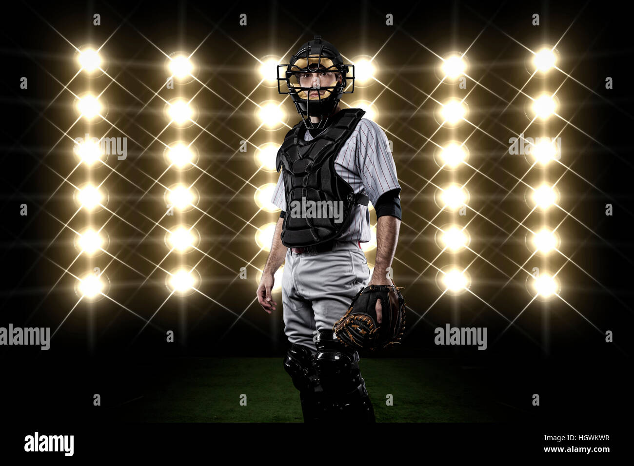 Catcher Player in front of lights Stock Photo - Alamy