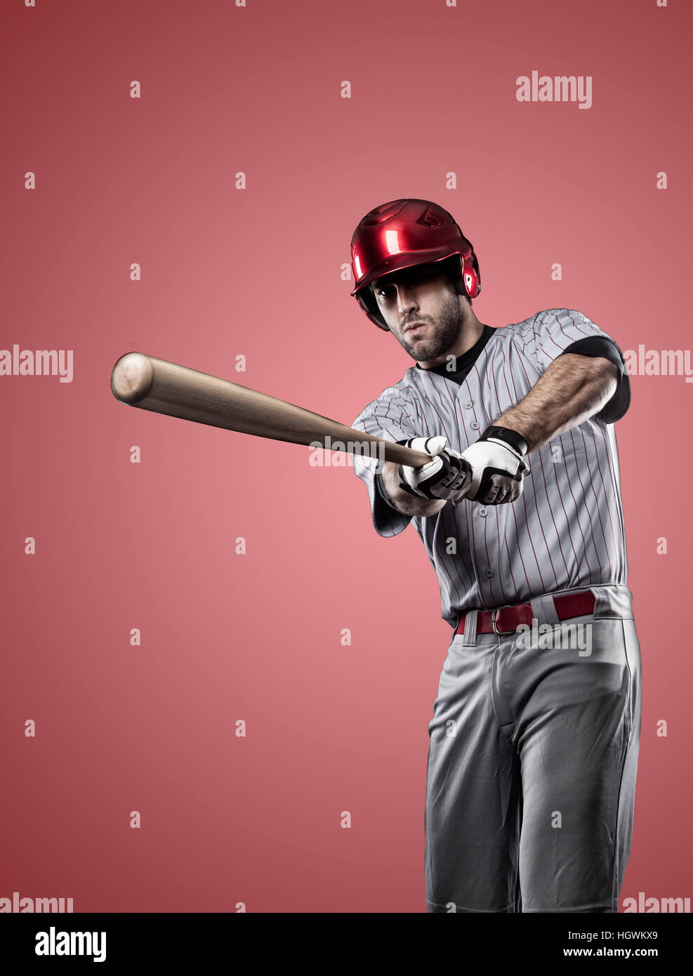 Baseball Player on a Red Uniform on red background Stock Photo - Alamy
