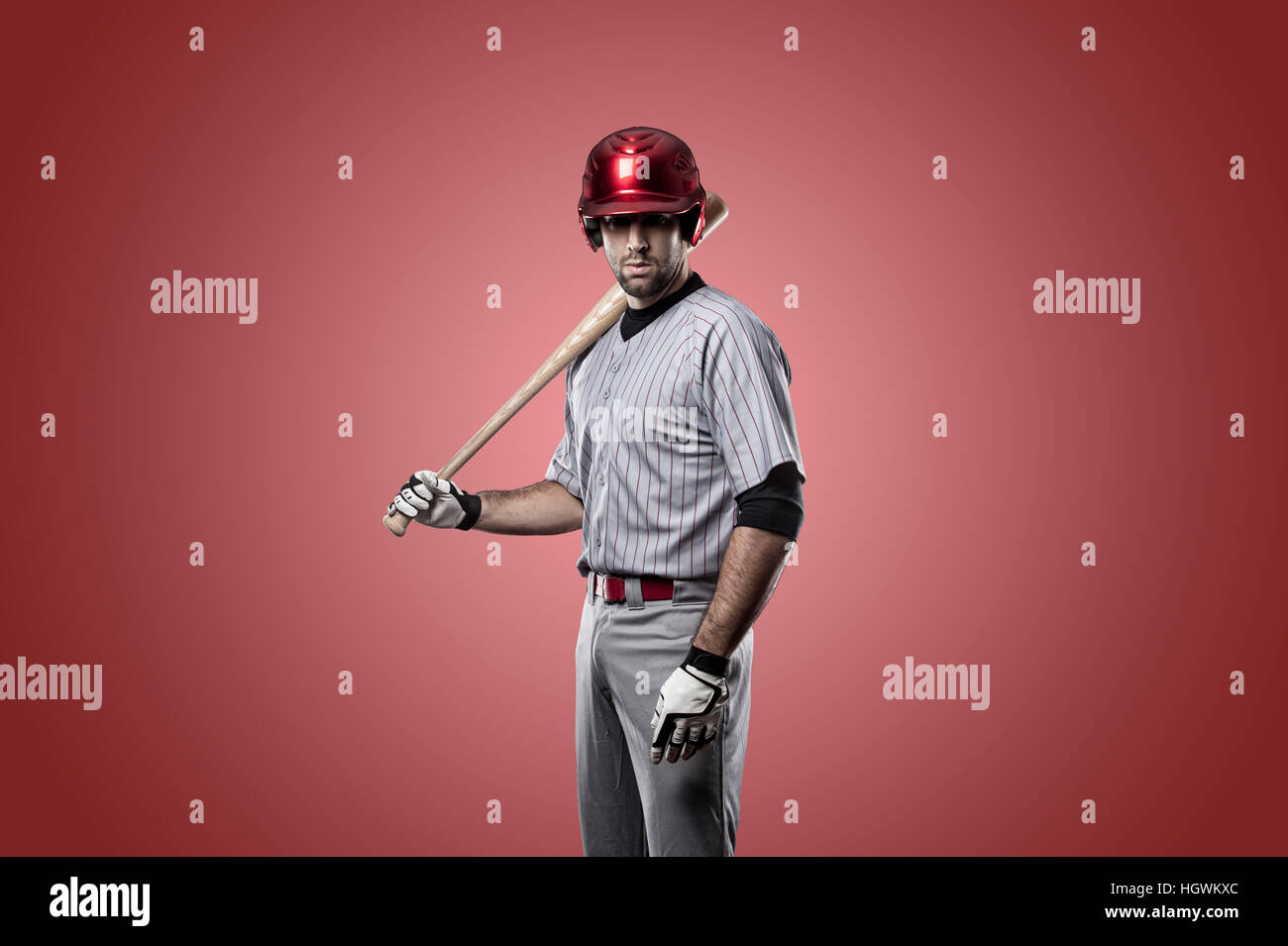 Baseball Player on a Red Uniform on red background Stock Photo - Alamy