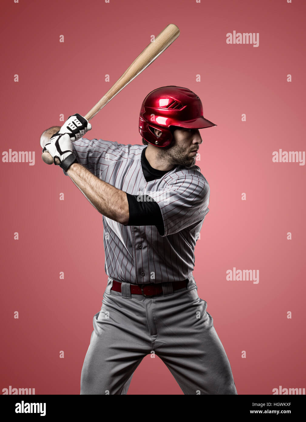 Baseball Player on a Red Uniform on red background Stock Photo - Alamy