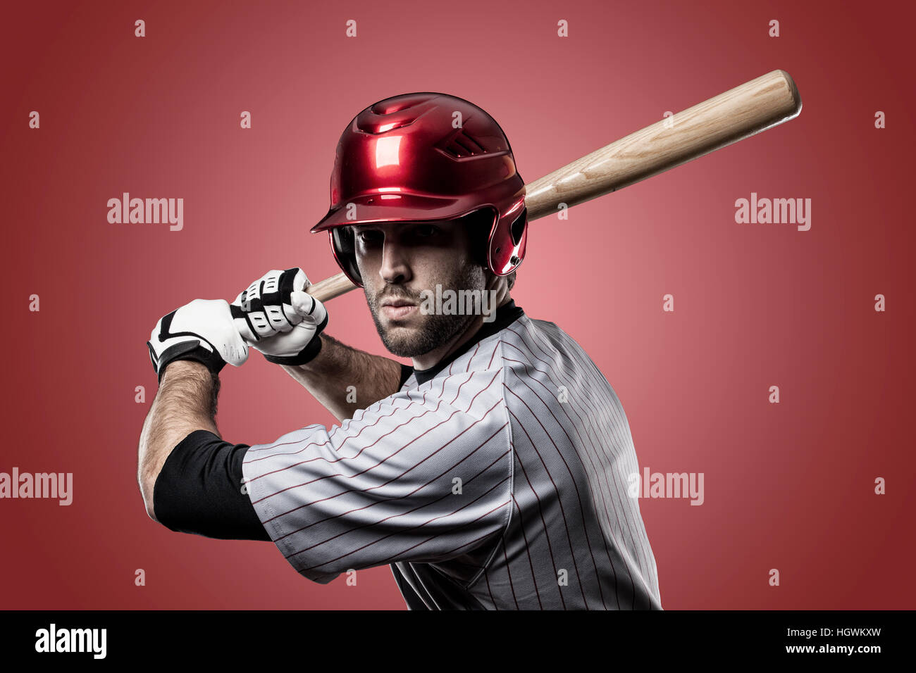 Baseball Player on a Red Uniform on red background Stock Photo - Alamy