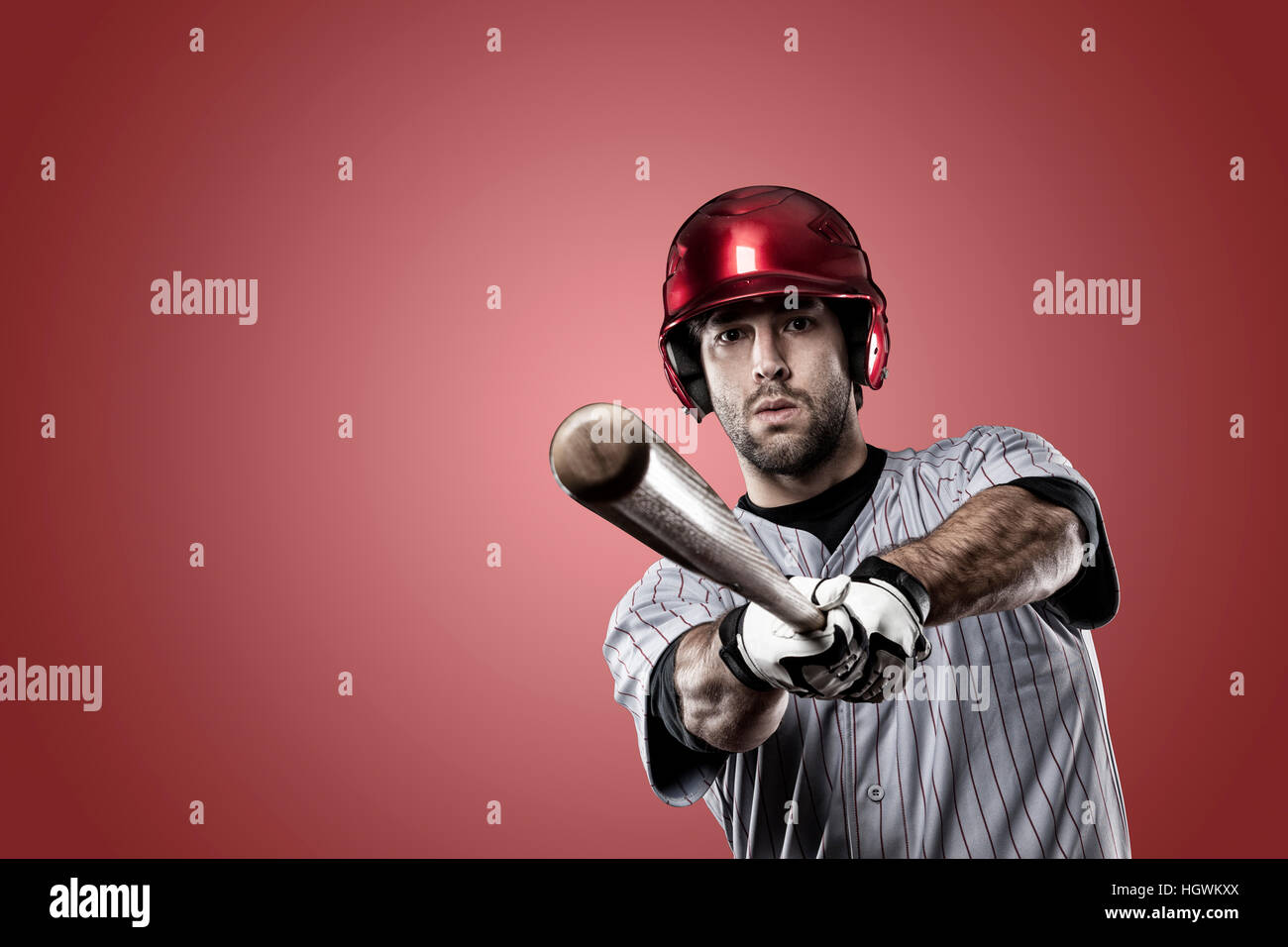 Baseball Player on a Red Uniform on red background Stock Photo - Alamy