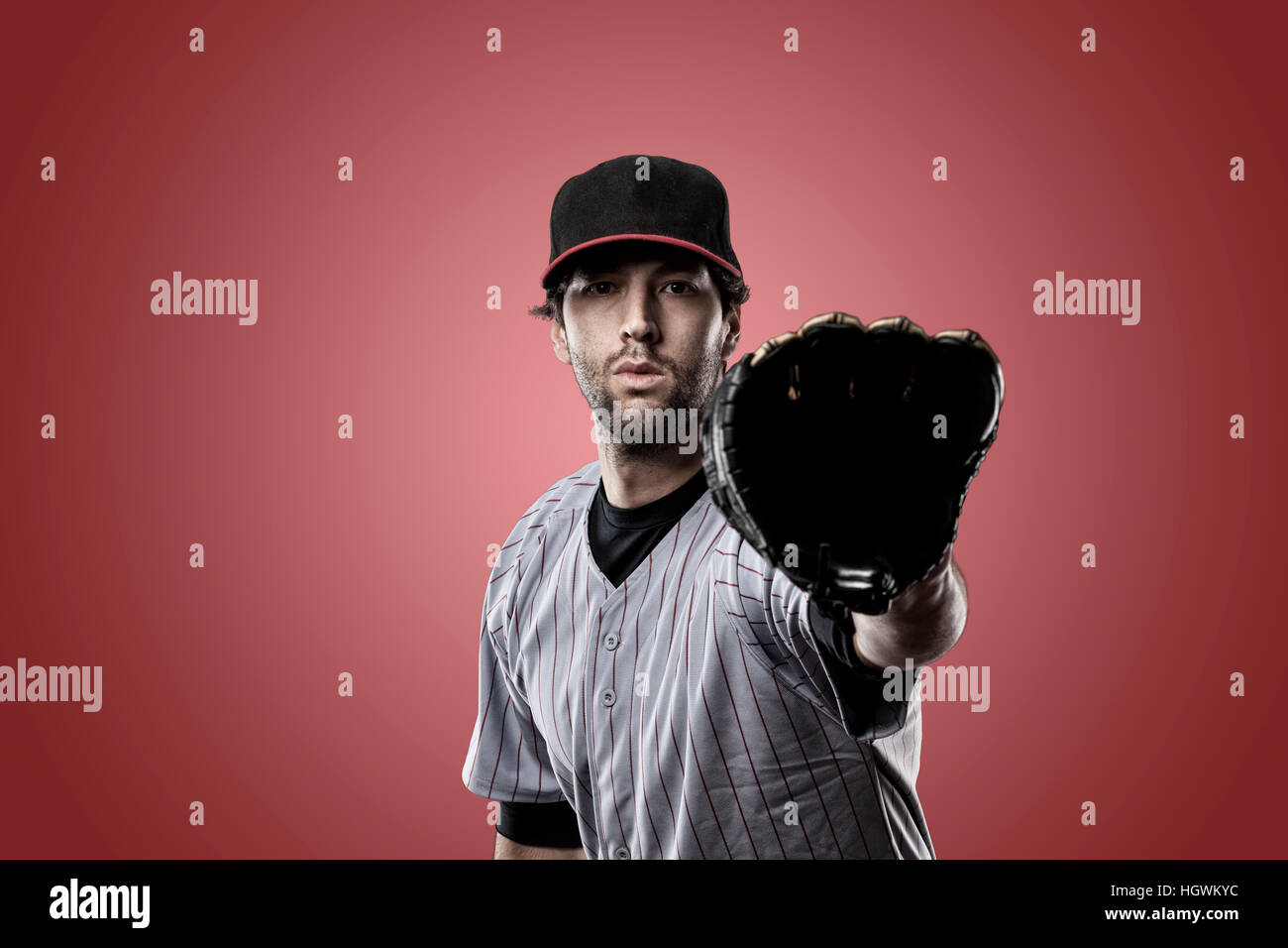 Baseball Player on a Red Uniform on red background Stock Photo - Alamy