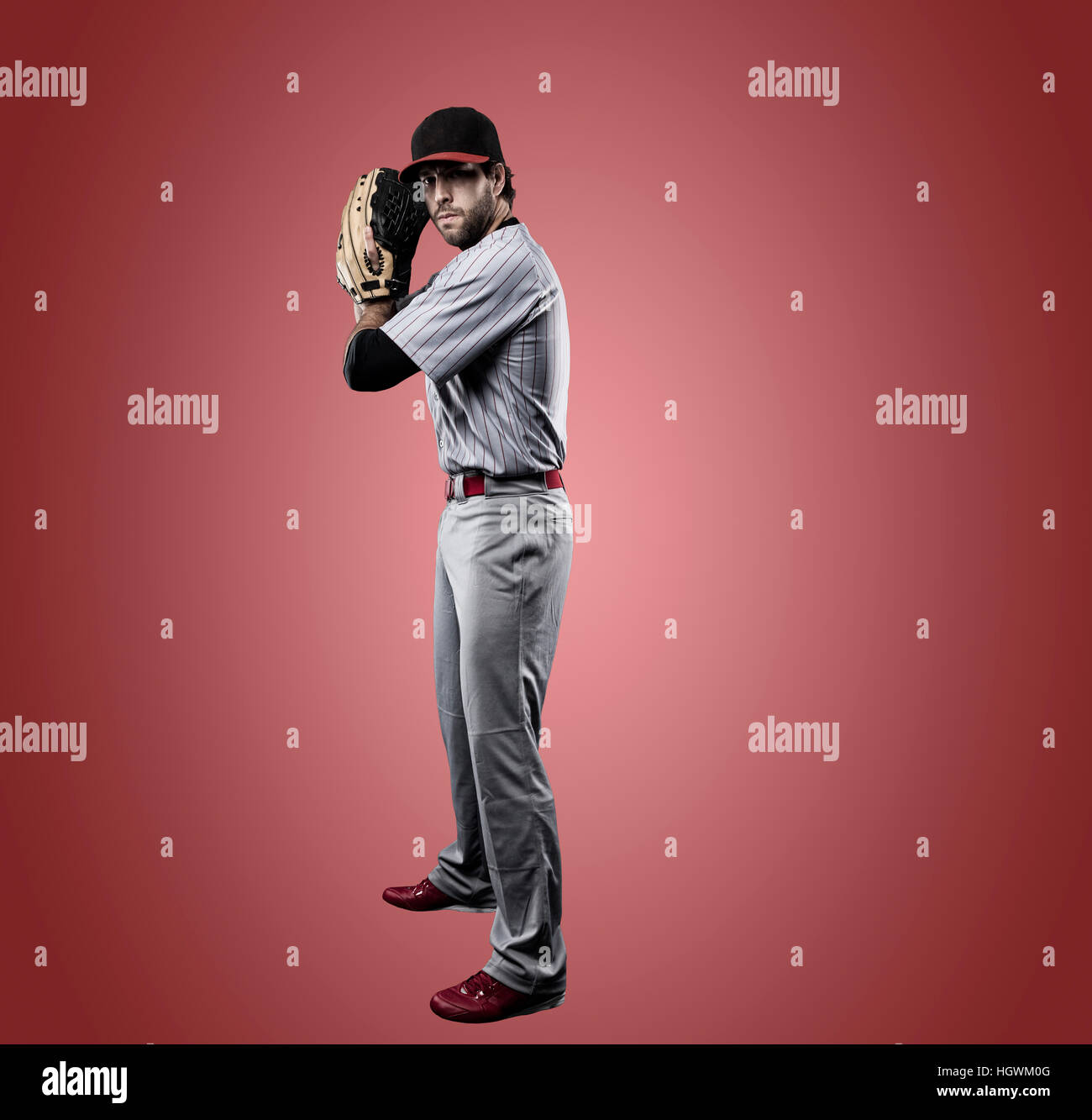 Pitcher Baseball Player on a Red Uniform on red background Stock Photo ...