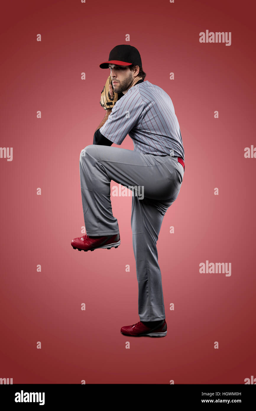 Pitcher Baseball Player on a Red Uniform on red background Stock Photo ...