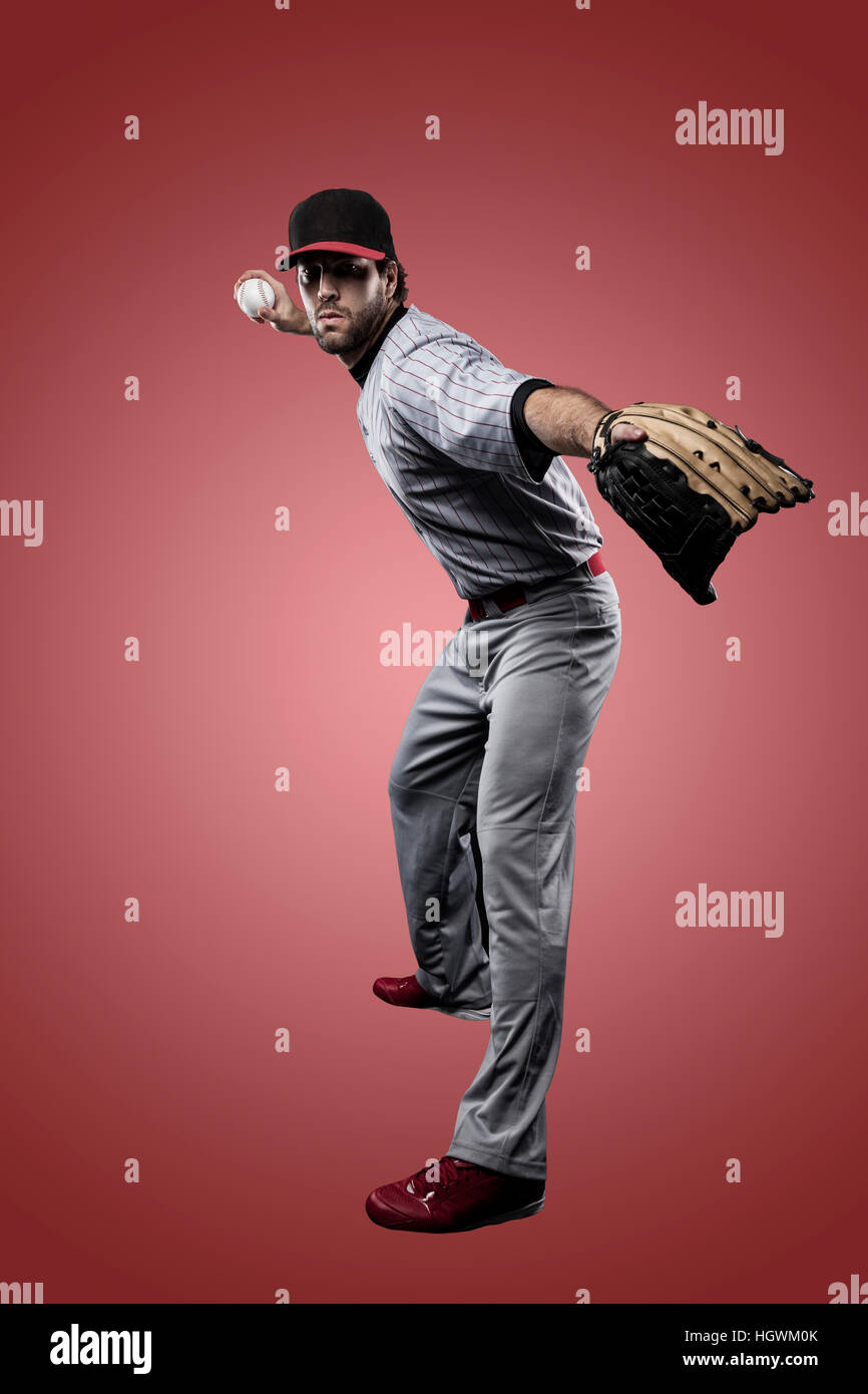 Pitcher Baseball Player on a Red Uniform on red background Stock Photo ...