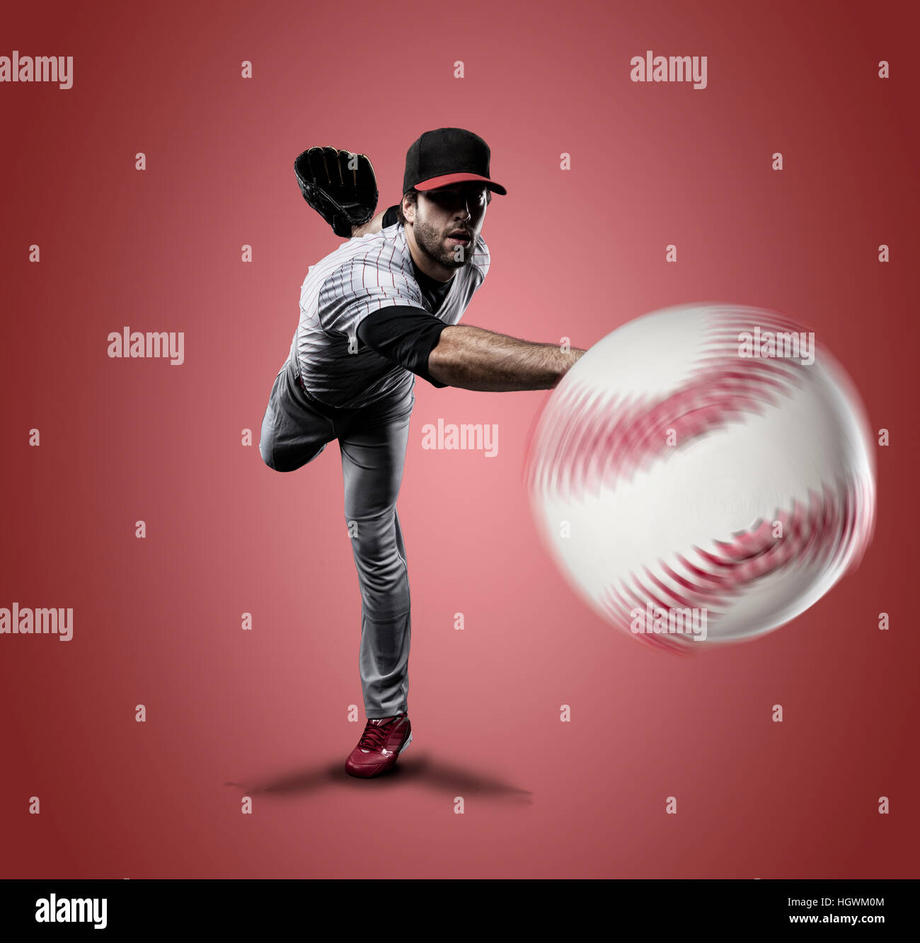 Pitcher Baseball Player on a Red Uniform on red background Stock Photo ...