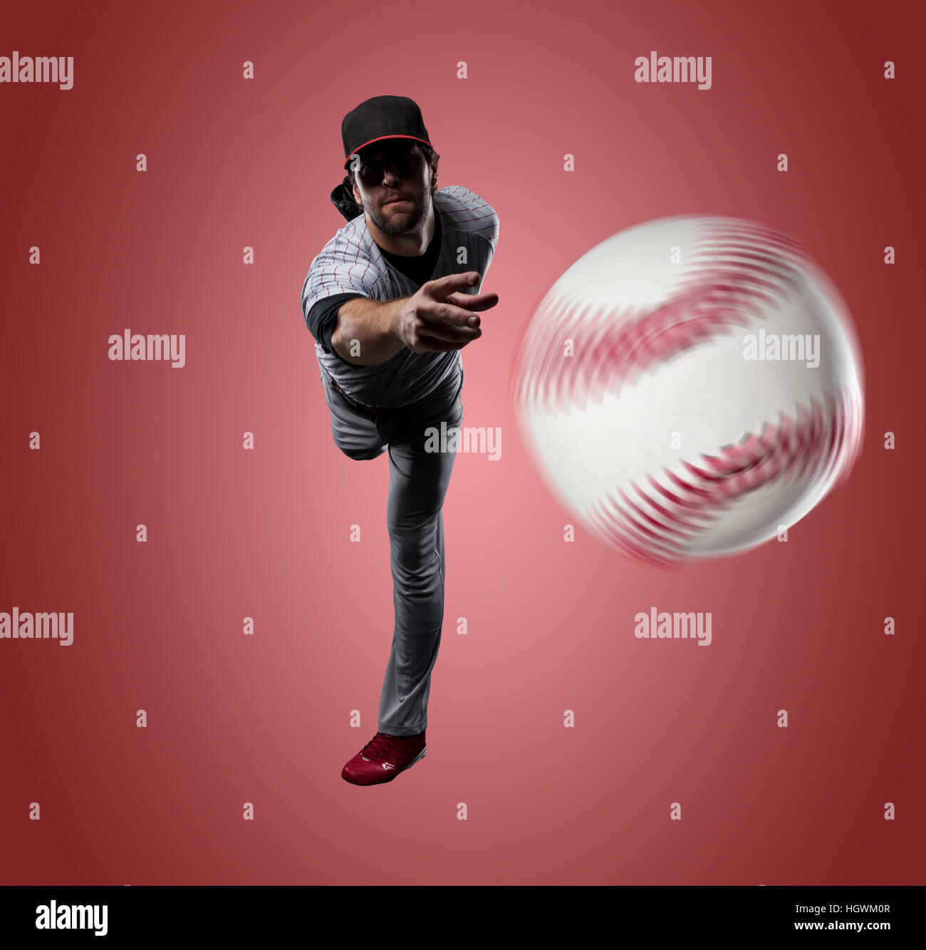Pitcher Baseball Player on a Red Uniform on red background Stock Photo ...