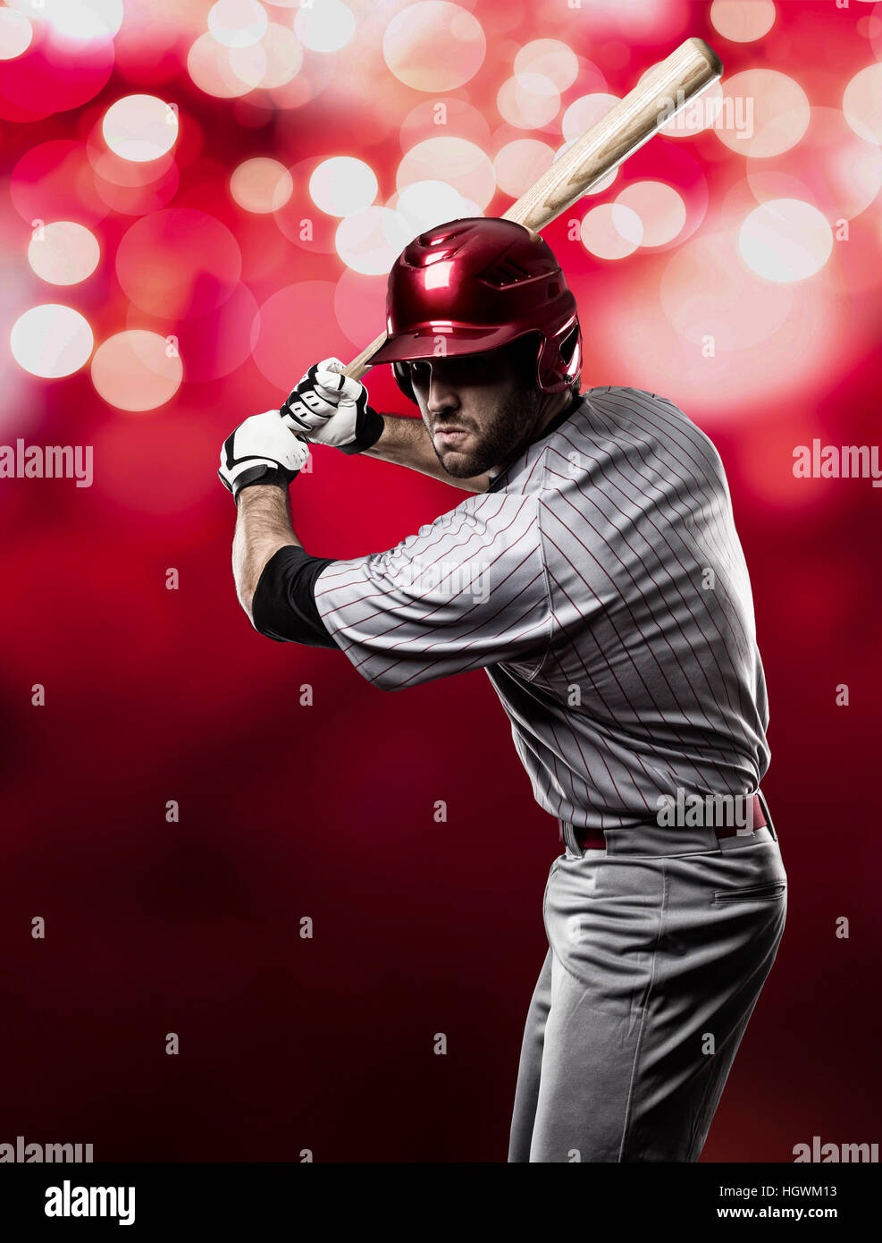 Baseball Player on a Red Uniform on red lights background Stock Photo ...