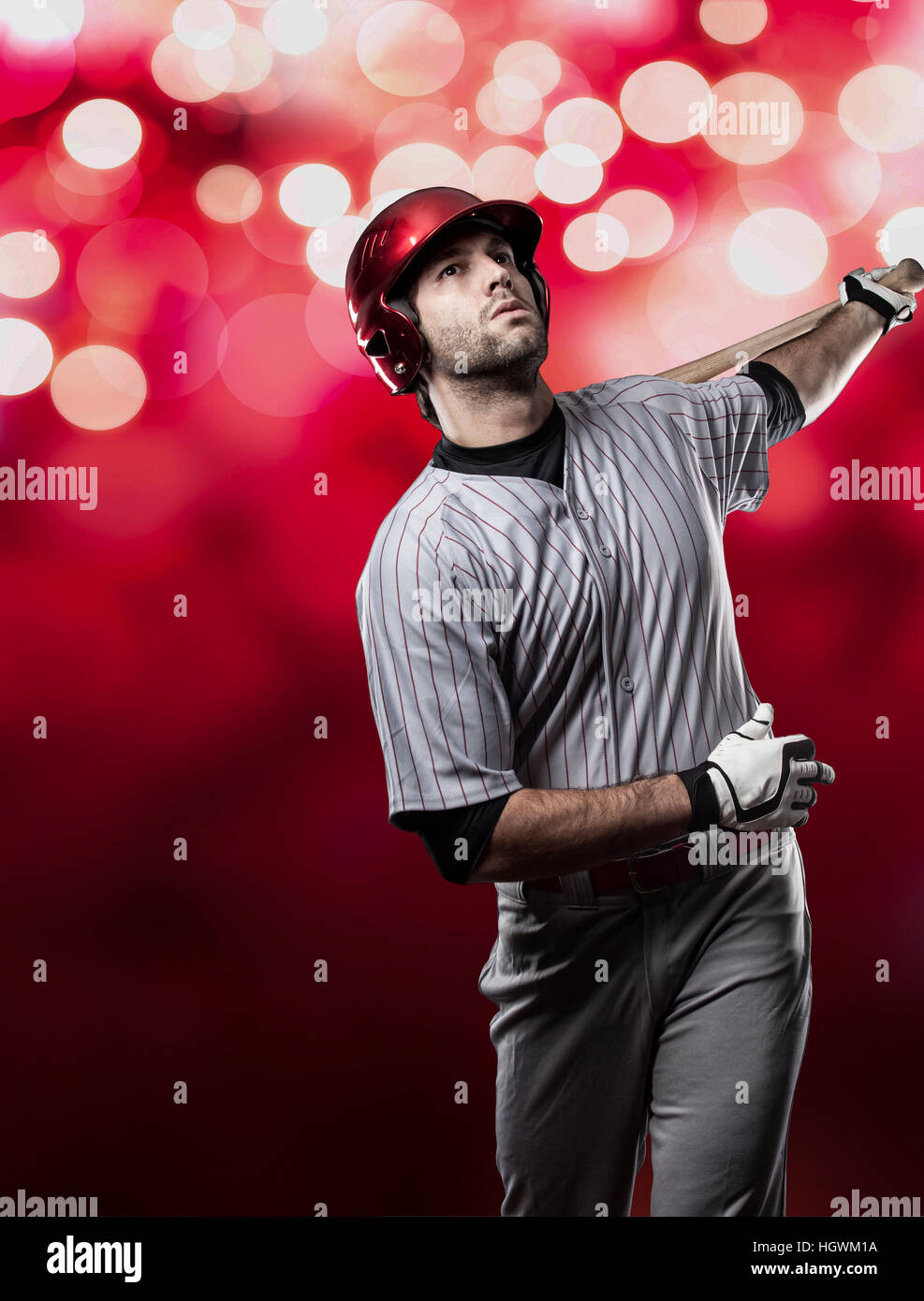 Baseball Player on a Red Uniform on red lights background Stock Photo ...