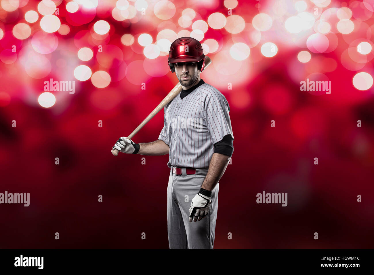 Baseball Player on a Red Uniform on red lights background Stock Photo ...