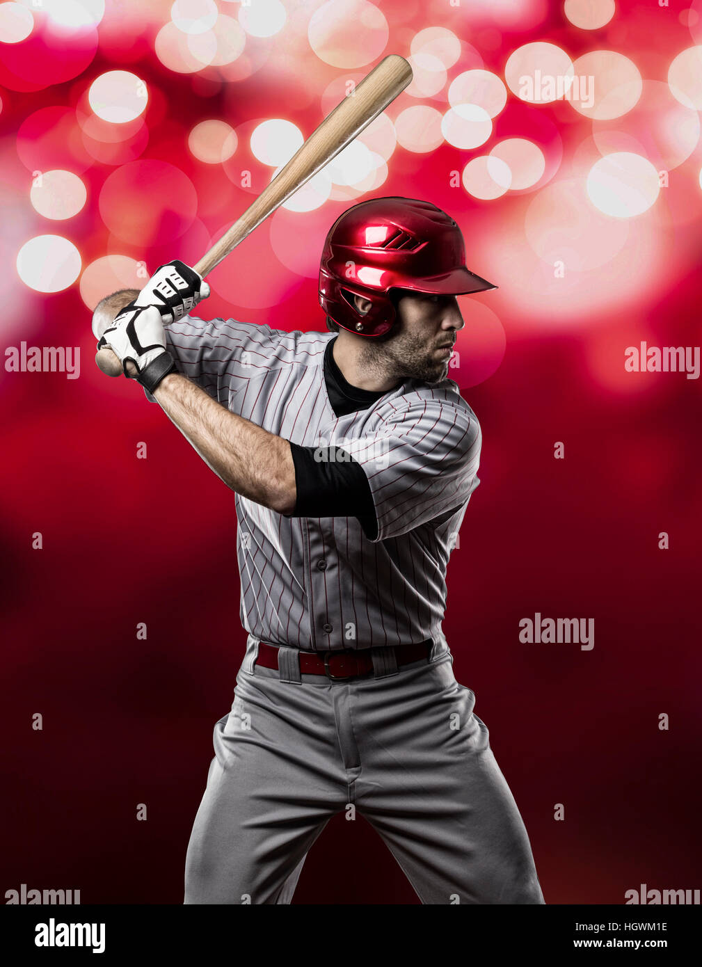 Baseball Player on a Red Uniform on red lights background Stock Photo ...