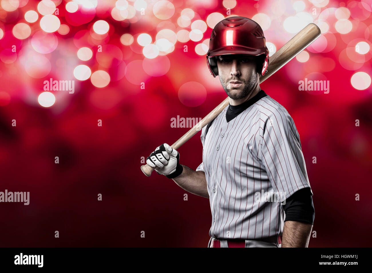 Baseball Player on a Red Uniform on red lights background Stock Photo ...