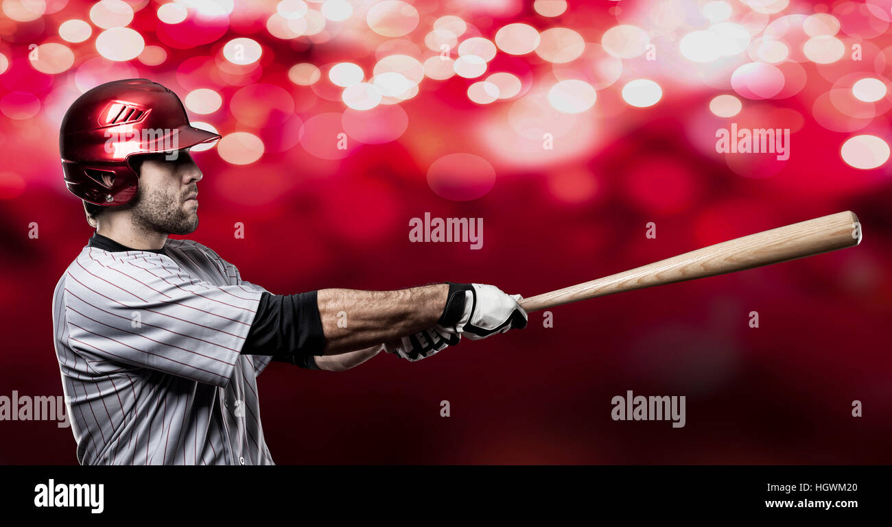 Baseball Player on a Red Uniform on red lights background Stock Photo ...