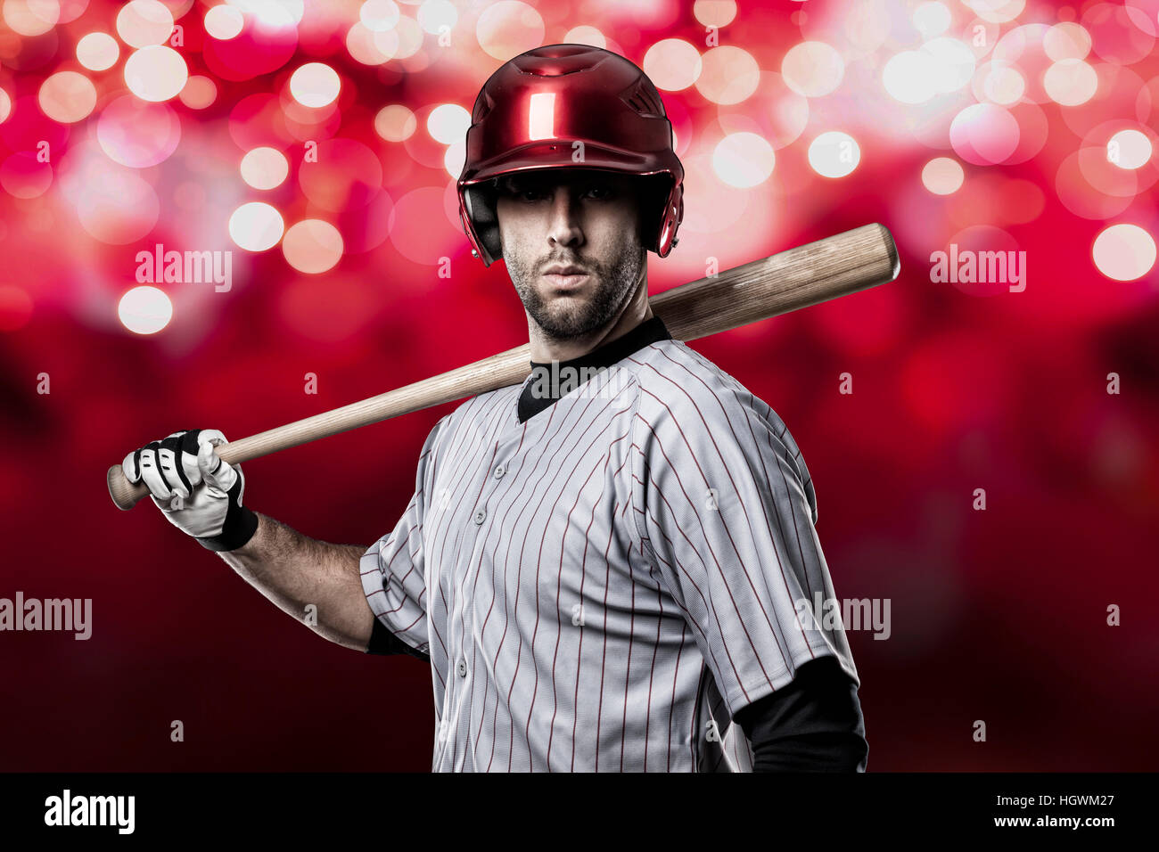 Baseball Player on a Red Uniform on red lights background Stock Photo ...