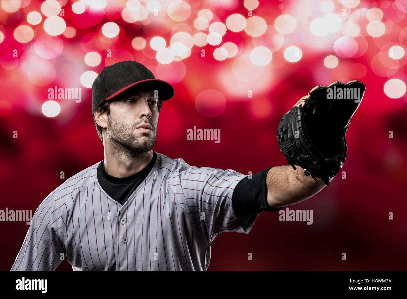 Baseball Player on a Red Uniform on red lights background Stock Photo ...