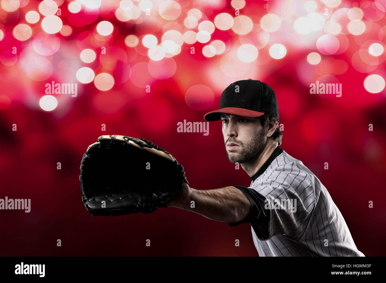 Baseball Player on a Red Uniform on red lights background Stock Photo ...
