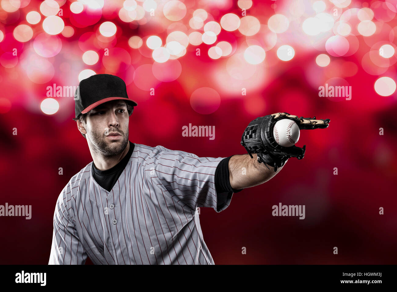 Baseball Player on a Red Uniform on red lights background Stock Photo ...