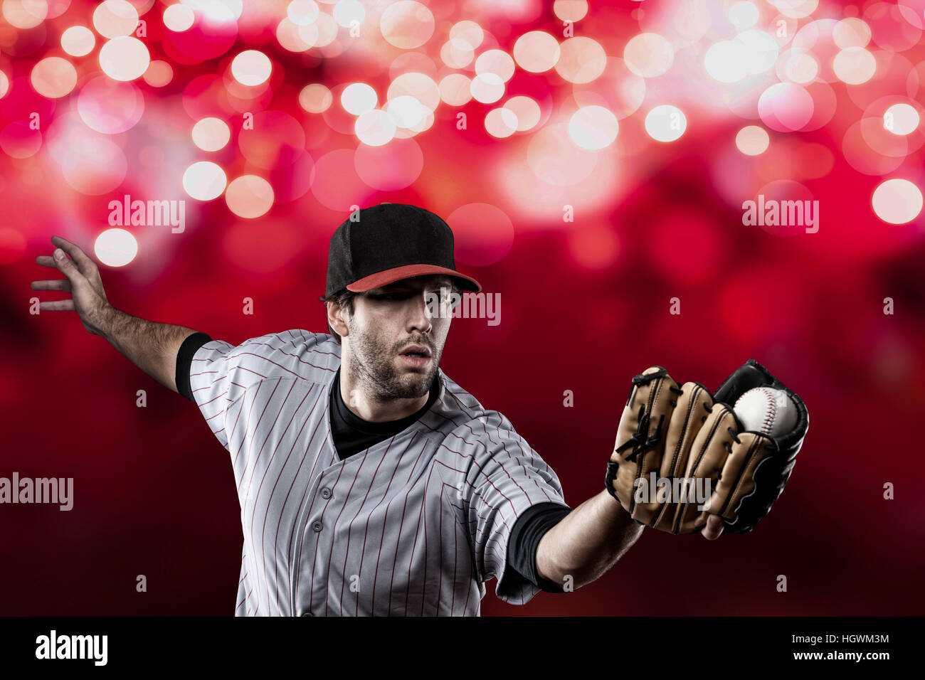 Baseball Player on a Red Uniform on red lights background Stock Photo ...