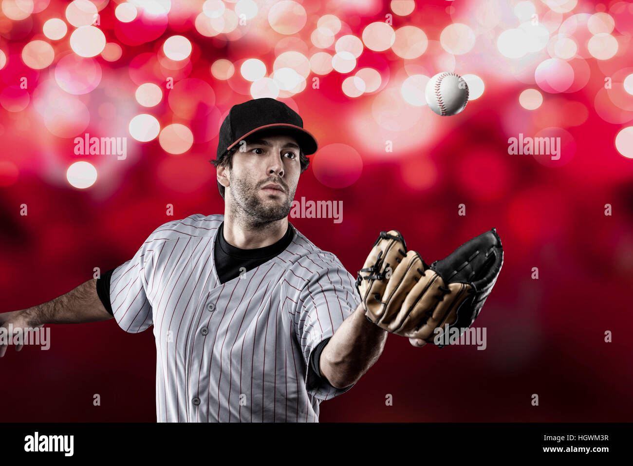 Baseball Player on a Red Uniform on red lights background Stock Photo ...