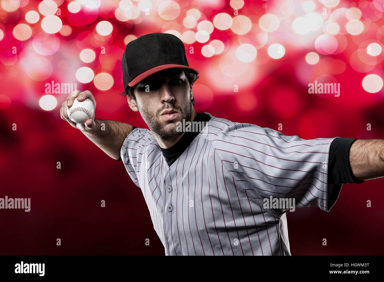 Baseball Player on a Red Uniform on red lights background Stock Photo ...