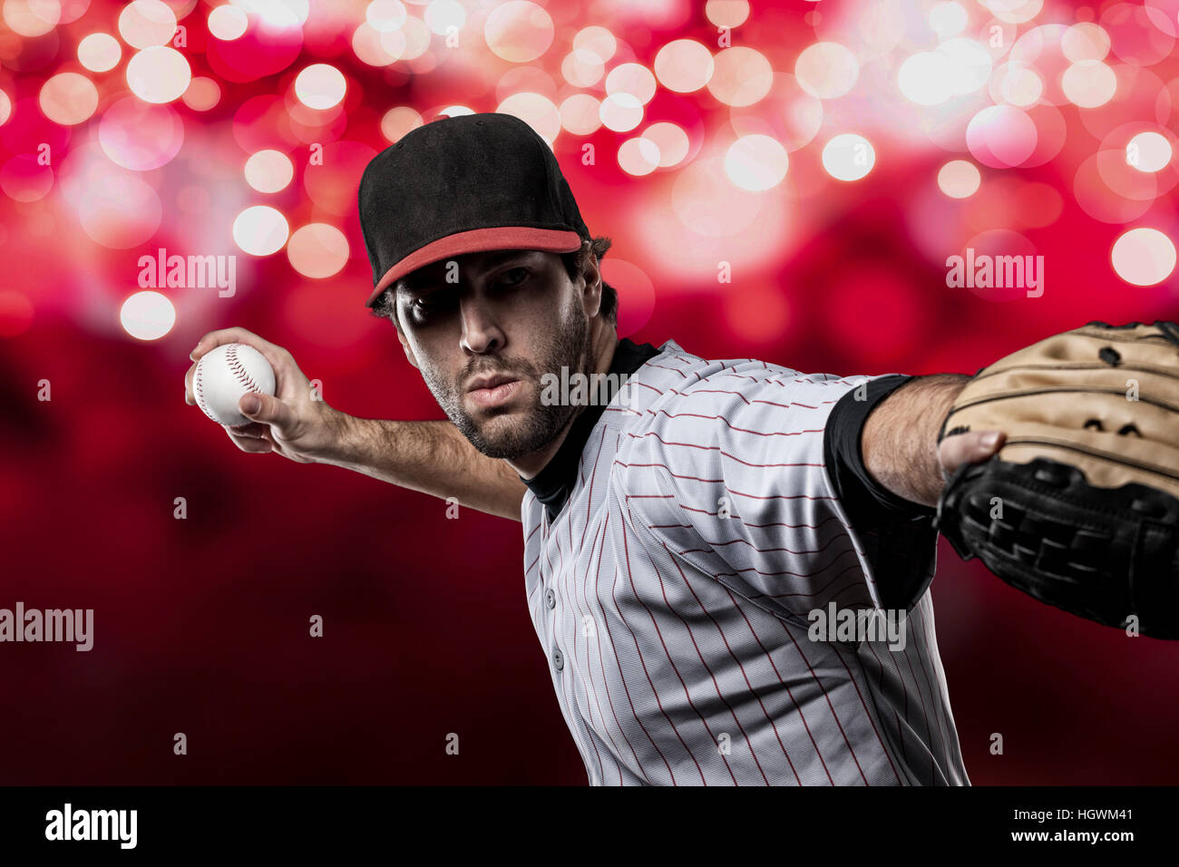 Baseball Player on a Red Uniform on red lights background Stock Photo ...