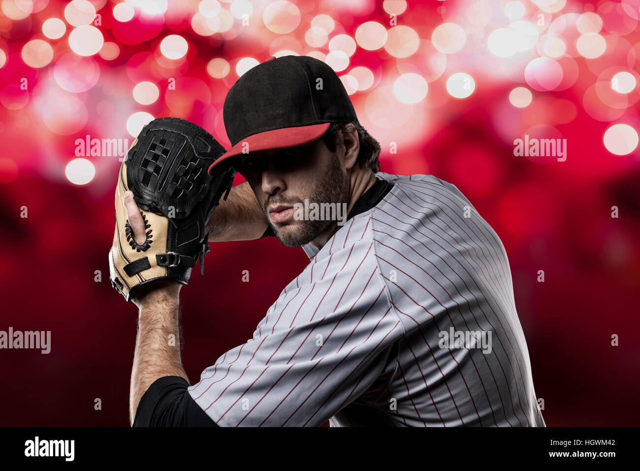 Baseball Player on a Red Uniform on red lights background Stock Photo ...
