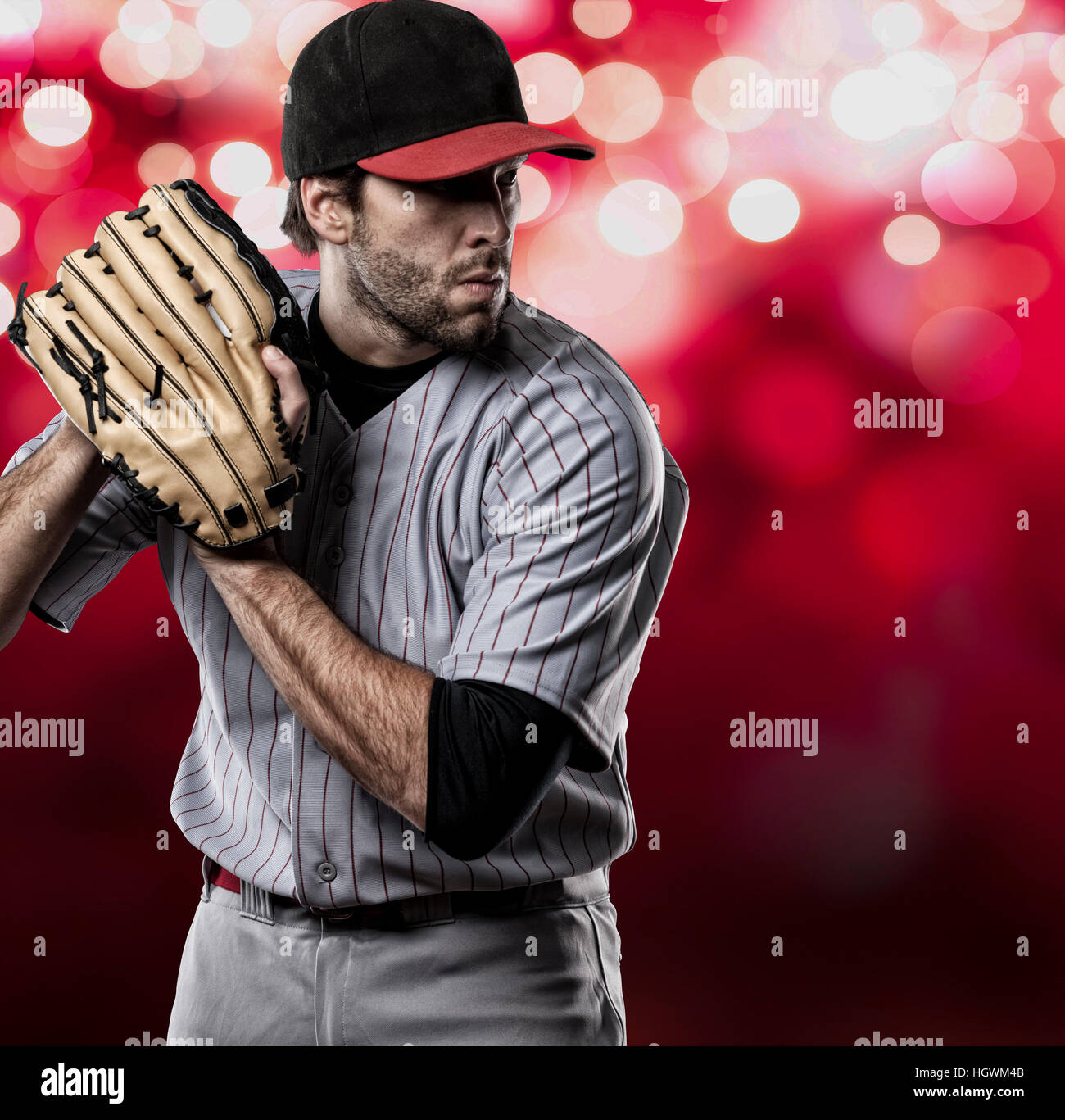 Baseball Player on a Red Uniform on red lights background Stock Photo ...