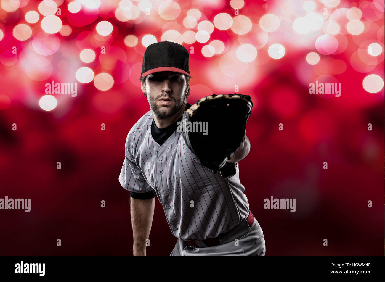 Baseball Player on a Red Uniform on red lights background Stock Photo ...