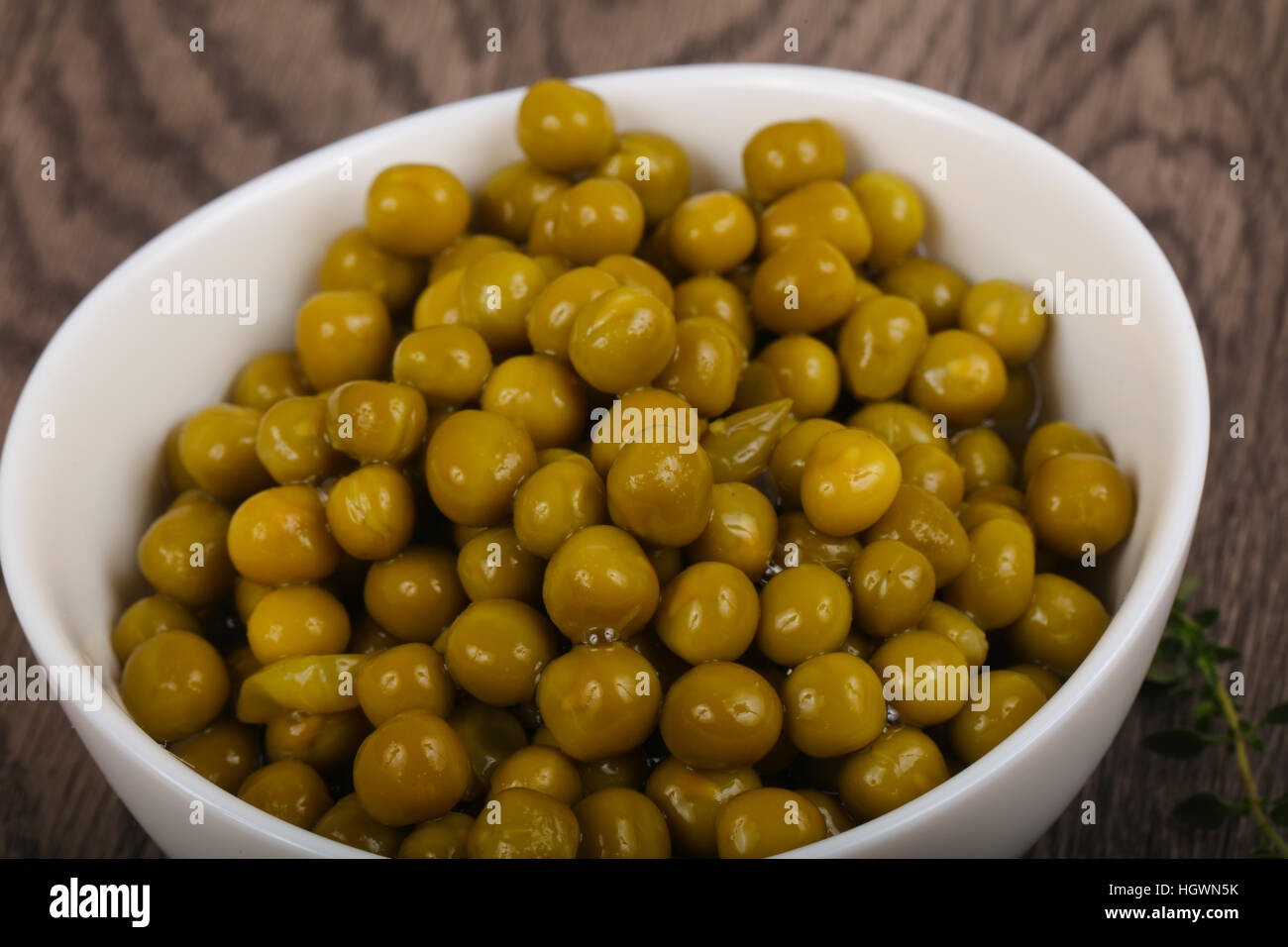 Pickled pea in the plate over wooden background Stock Photo - Alamy