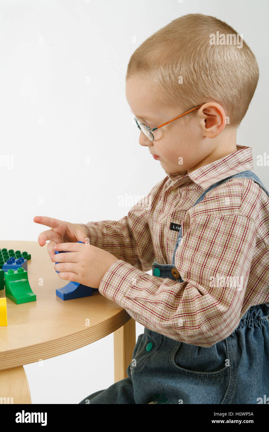 4-year old boy is playing with Lego bricks Stock Photo - Alamy