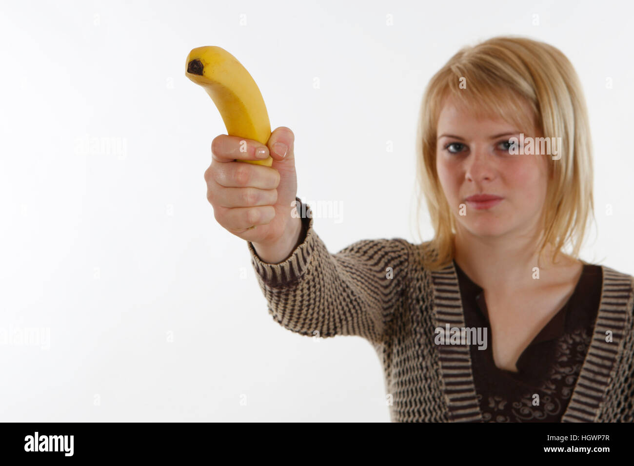 Woman holds banana like a weapon Stock Photo - Alamy