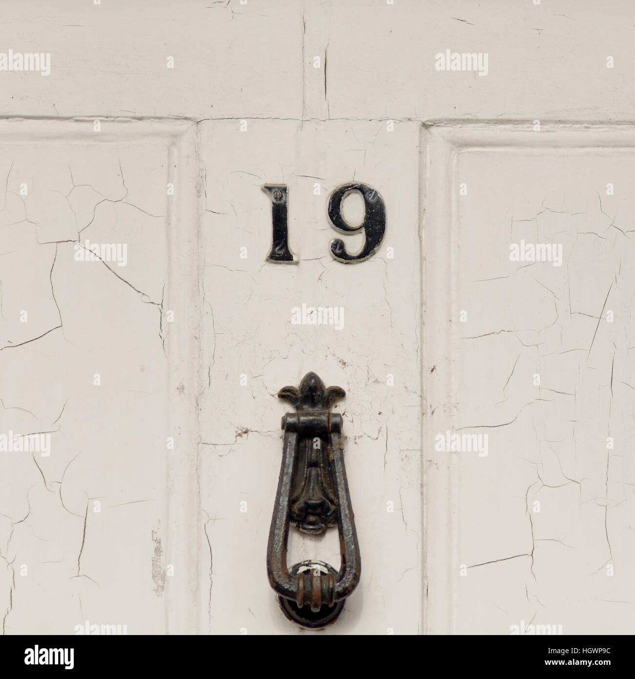 House Number 19 sign on door with flaking paint and door knocker Stock ...