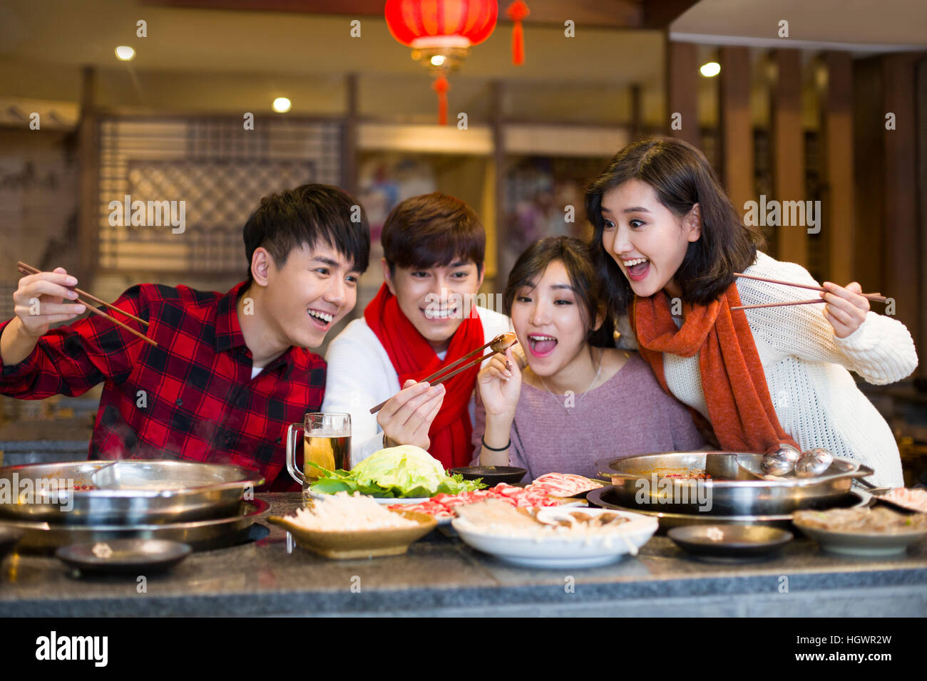 Young friends having dinner in hotpot restaurant Stock Photo - Alamy