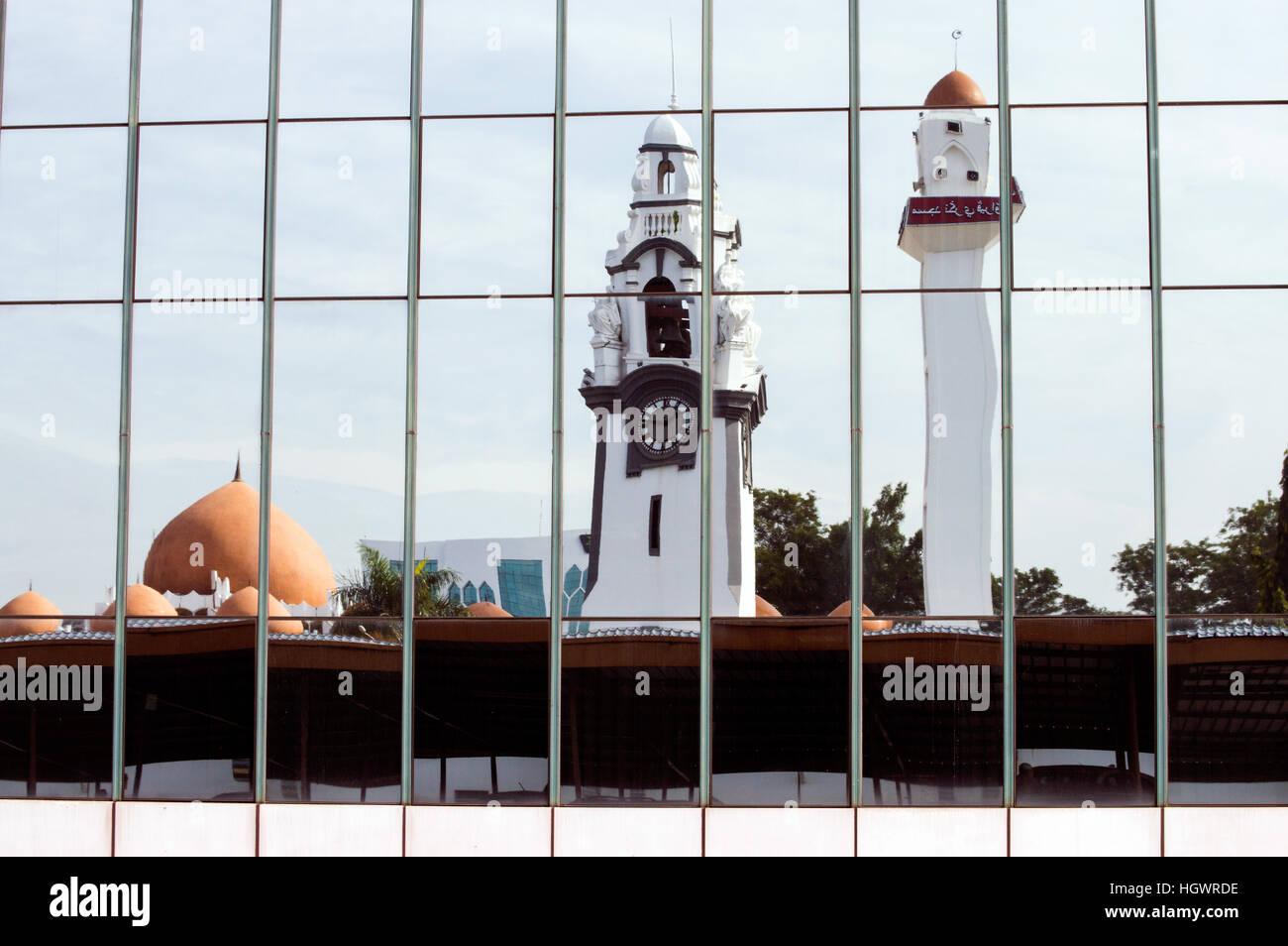 Reflection in modern building window of Birch Memorial Clock Tower and ...