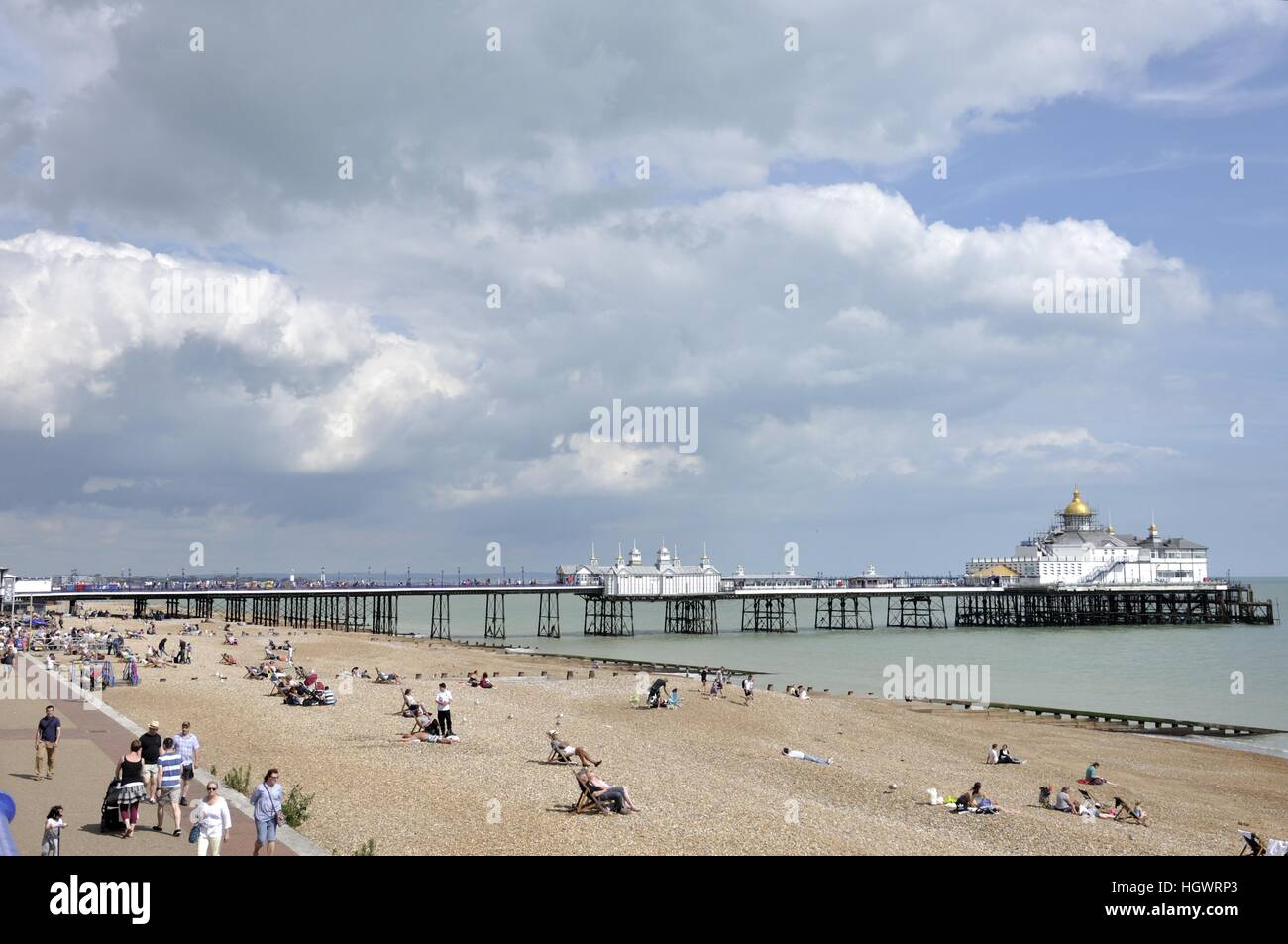 Eastbourne beach and pier with people enjoying a warm day Stock Photo ...
