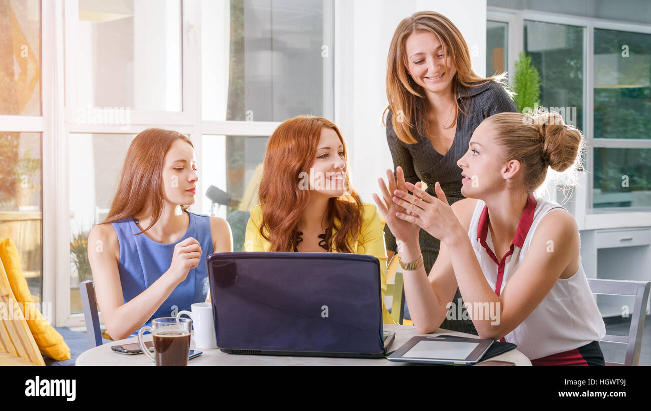 Group of four pretty businesswoman working togeather with new startup ...