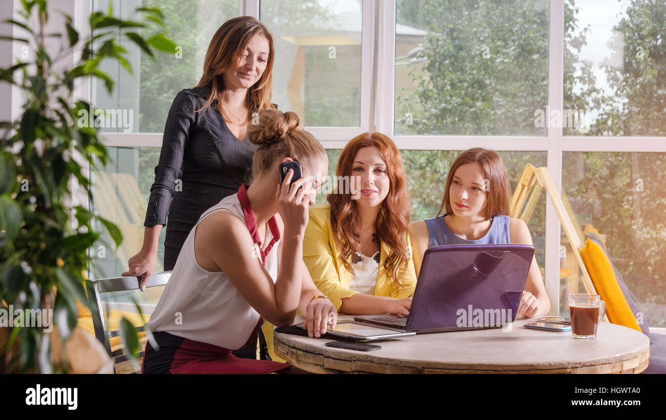 Group of four pretty businesswoman working togeather with new startup ...