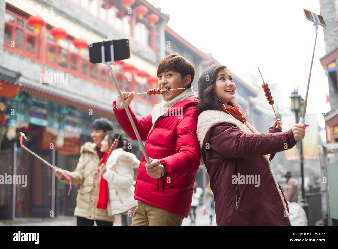 Young couple taking self portrait with smart phones Stock Photo - Alamy