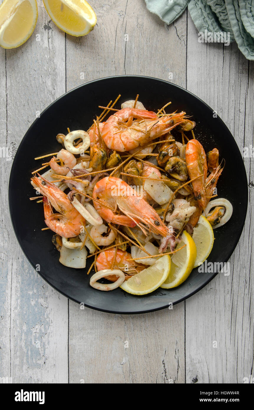 Deep-fried seafood mix with spaghetti Stock Photo - Alamy