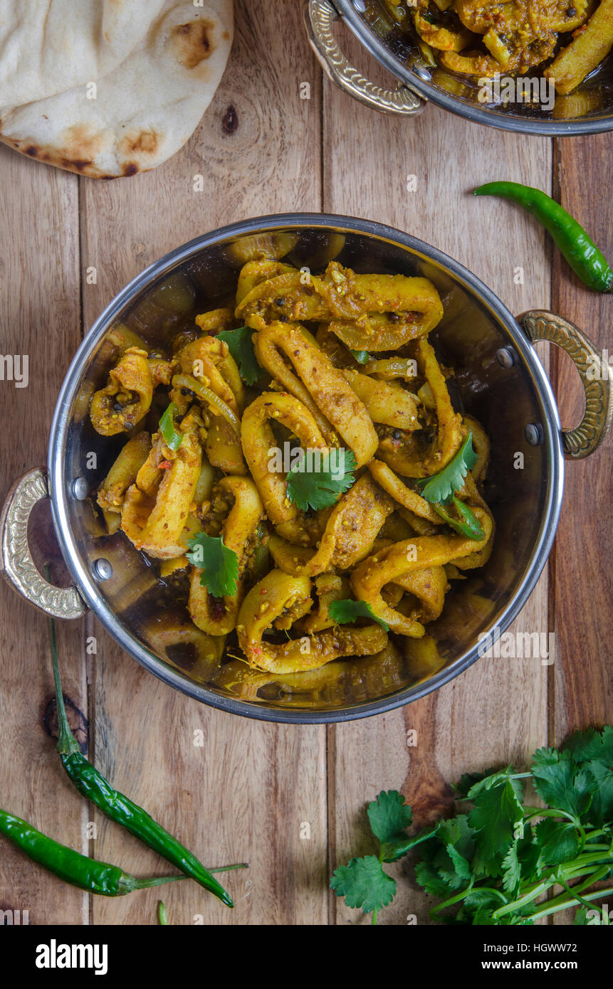 Traditional Indian squid curry with chapatis bread Stock Photo - Alamy