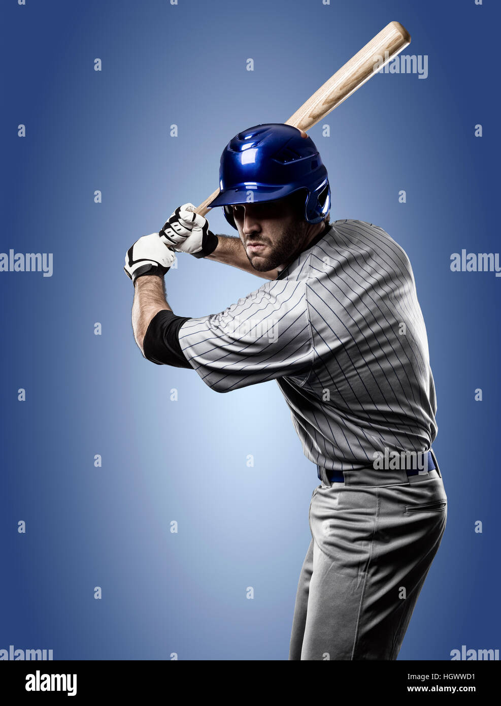 Baseball Player on a Blue Uniform on blue background Stock Photo - Alamy