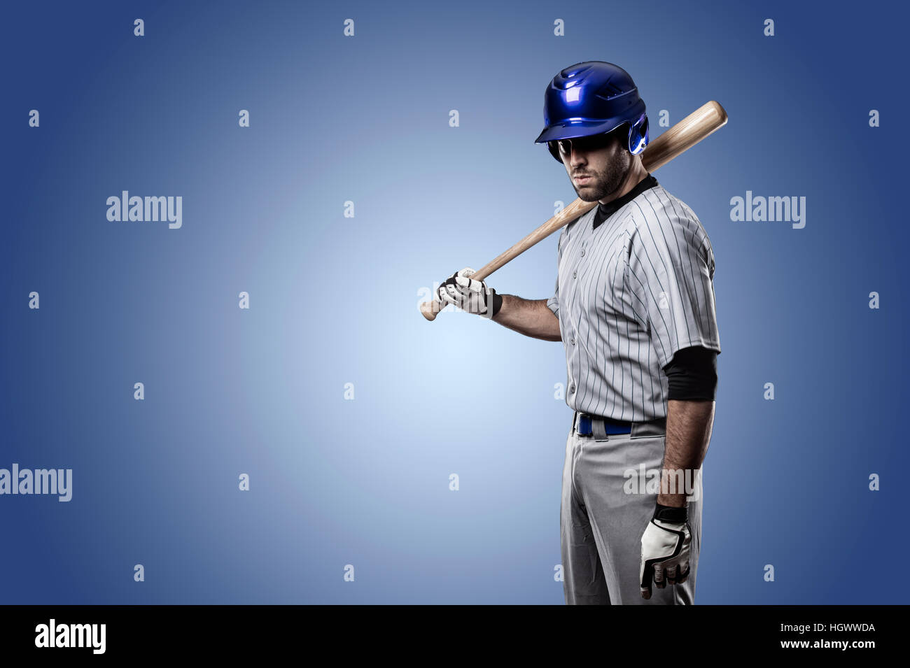 Baseball Player on a Blue Uniform on blue background Stock Photo - Alamy