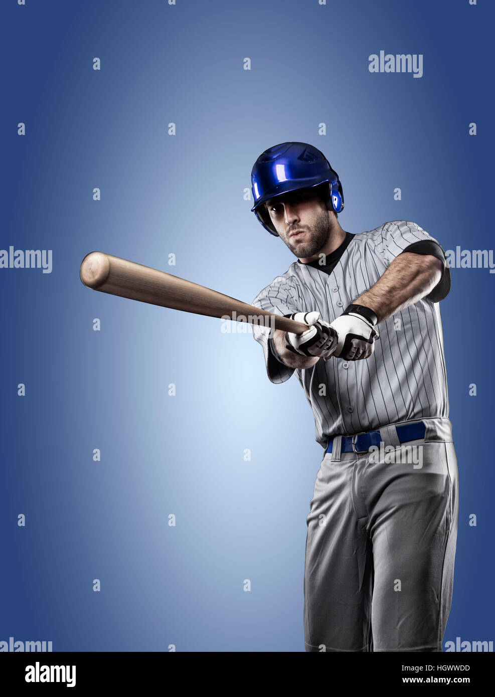 Baseball Player on a Blue Uniform on blue background Stock Photo - Alamy