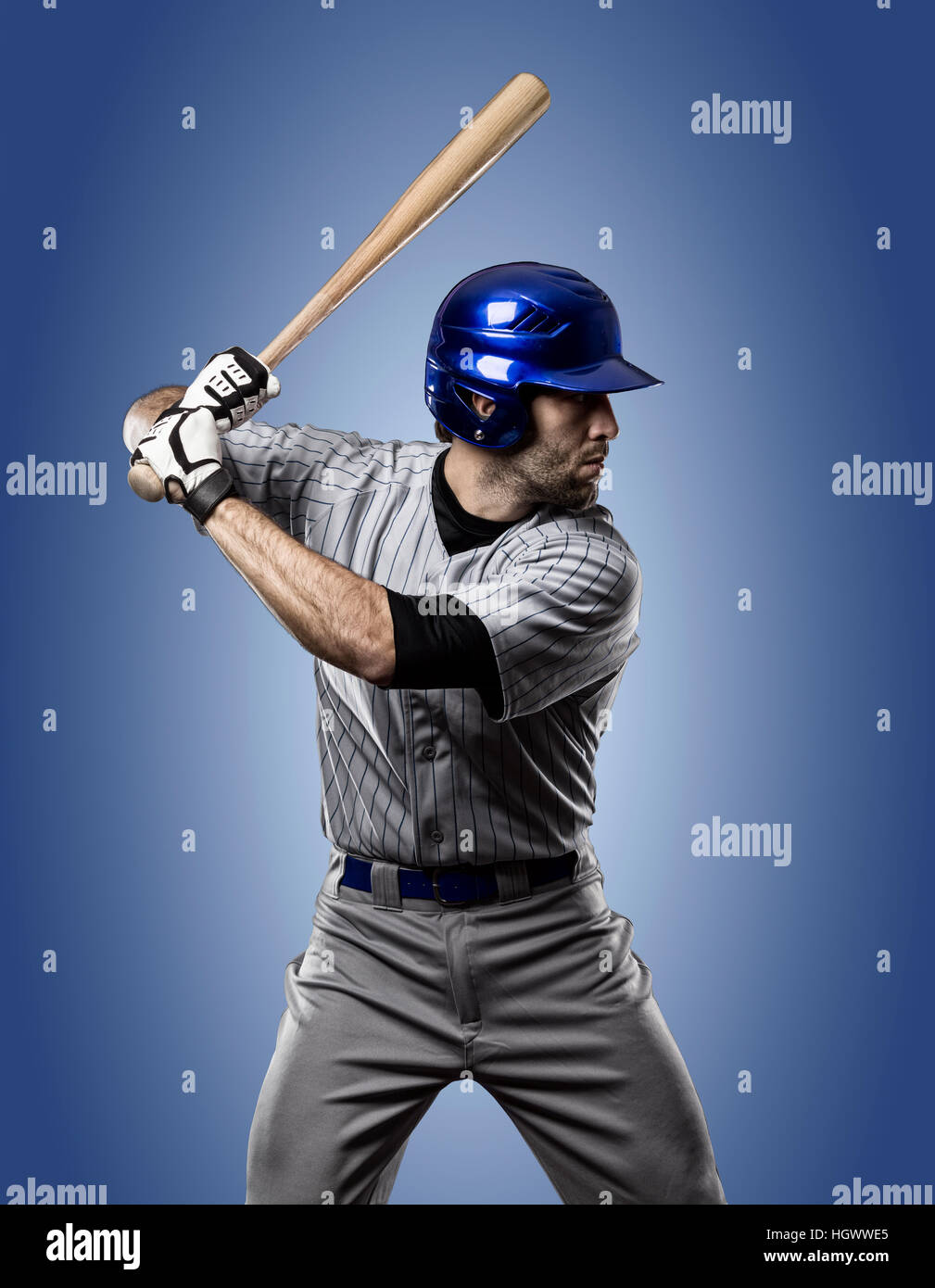 Baseball Player on a Blue Uniform on blue background Stock Photo - Alamy